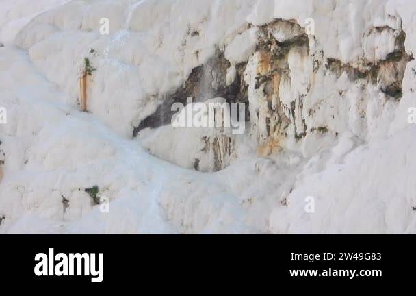 White travertine rock formed with the calcium carbonate mineral in the ...