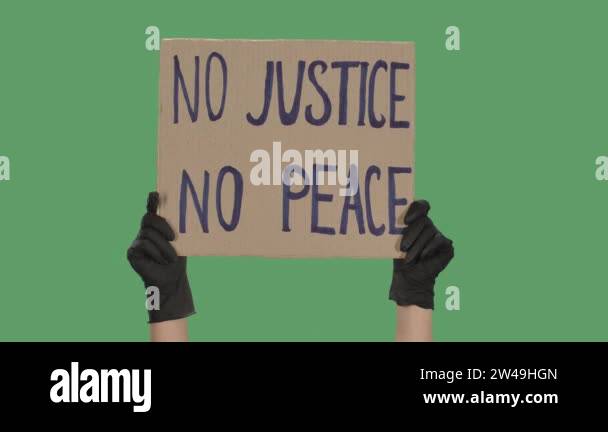 Female hands in black gloves pick up a poster from a cardboard box that ...