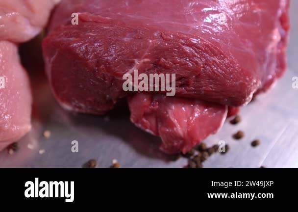 Raw beef & pork meat for cooking filmed in restaurant kitchen in close ...