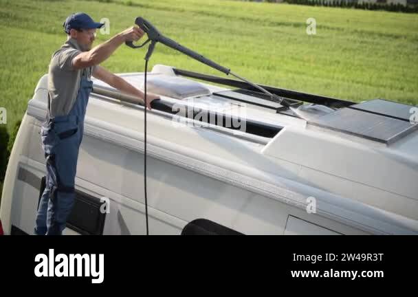 Male RV Owner Cleaning Roof Of Vehicle With Pressure Washing Wand By ...