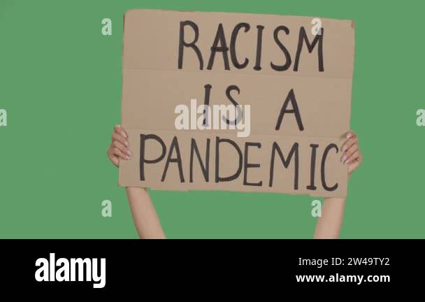RACISM IS A PANDEMIC. Protest text message on cardboard. Stop racism ...