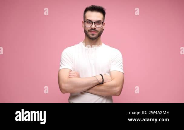 handsome fashion model looking down, raising his look at the camera ...