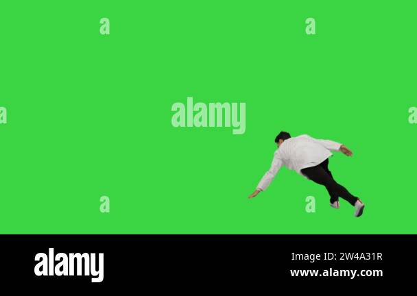 Young male doctor dancing breakdance, adjusting his robe looking at ...