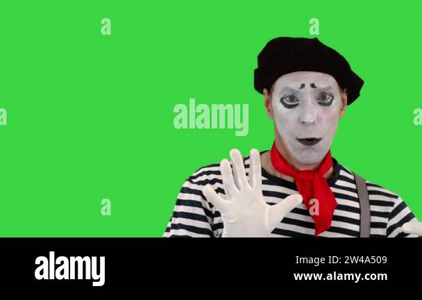 Young funny mime behind an invisible wall on a Green Screen, Chroma Key ...
