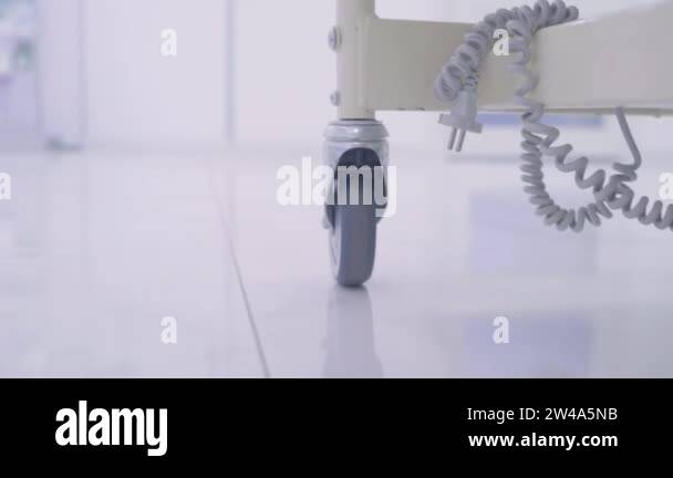 Wheel of mobile medical device moving to provide patient with emergency ...