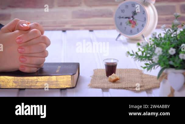 Young woman reading the Bible and taking communion - the wine and the ...