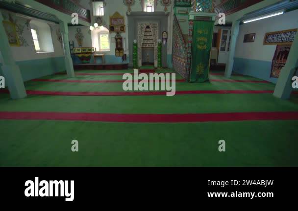 Muslim mosque teacher is reading quran in small historic wooden masjid ...