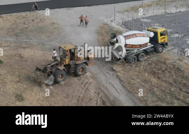 Bulldozer is Towing, Pulling out a Concrete Mixer Stuck in the Sand at ...
