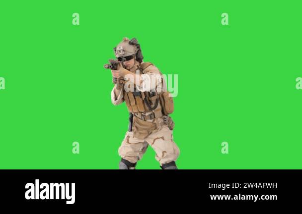 Soldier shooting with assault rifle and reloading on a Green Screen ...