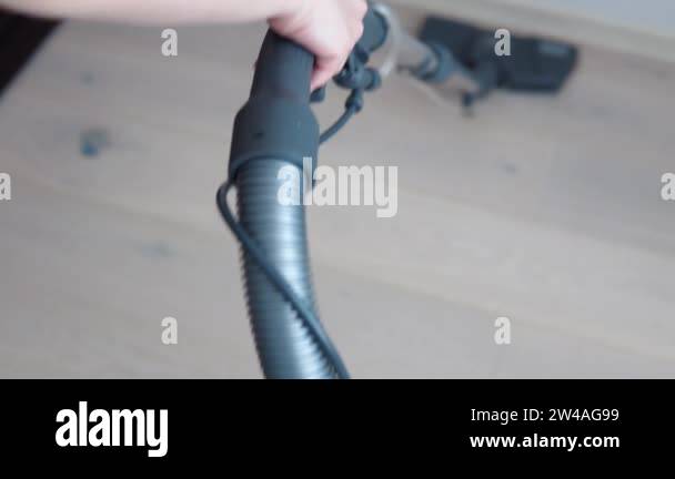 Vacuuming the light oak floor with water. Wet cleaning of the house ...