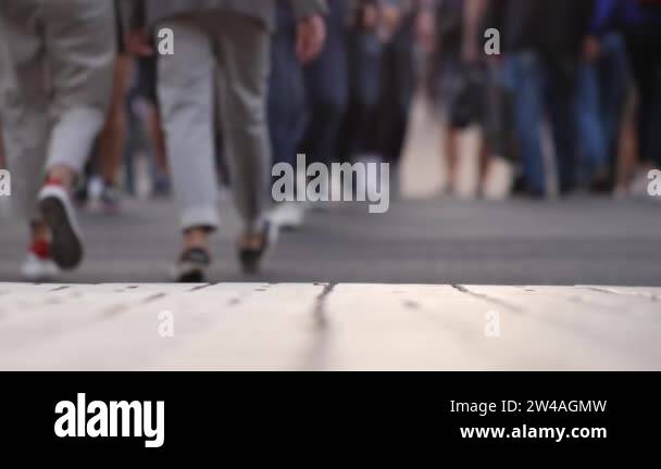 Closeup view of human feet people walking on crowded street in slow ...