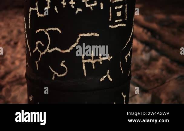 Black barrel that glows with ancient viking rune symbols on a winter ...