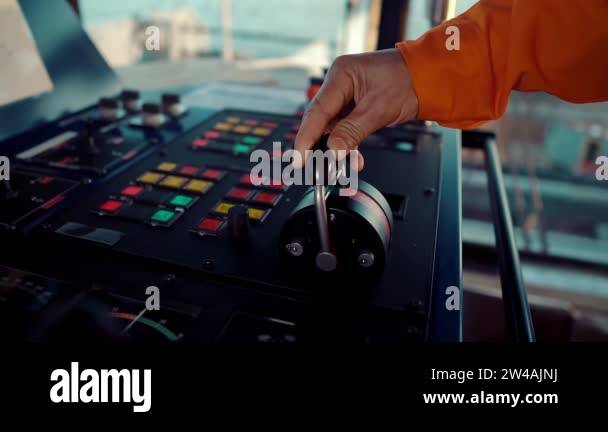 Filipino deck Officer on bridge of vessel or ship. He is maneuvering ...