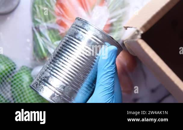 Door delivery of goods. Order picker packing foods in a cardboard boxes ...