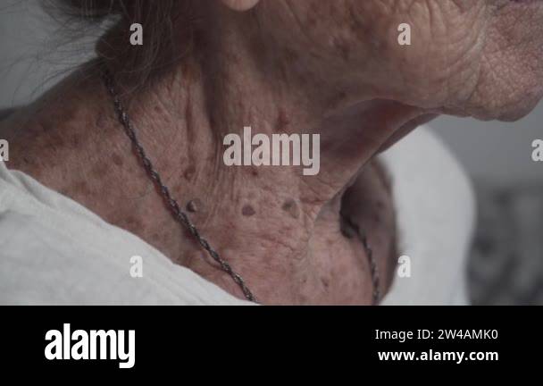 The pulse is reduced in the artery of senior woman neck. High blood ...