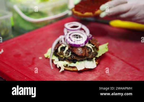 Chef cook prepares hamburger in restaurant kitchen.Video clip of burger ...
