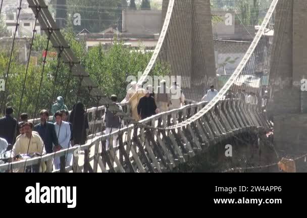 People cross a bridge in Gilgit Stock Video Footage - Alamy