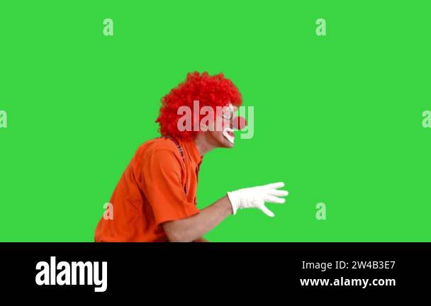 Clown prowling and making be quiet gesture to camera on a Green Screen ...