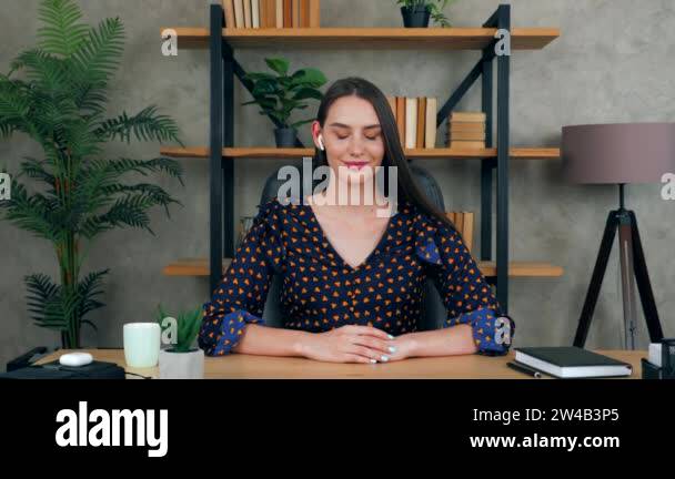 Smiling positive beautiful woman teacher tutor sitting on chair at ...