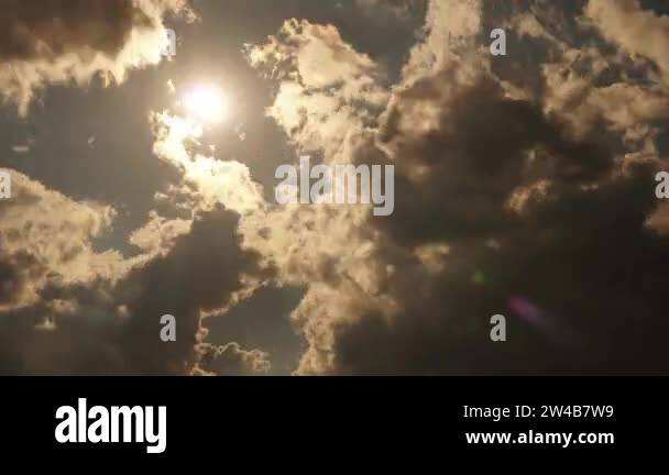Beautiful heavy sunny cloudscape. Timelapse of golden fluffy clouds and ...