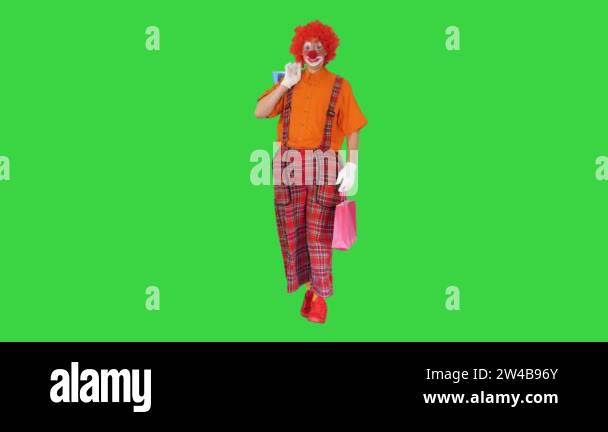 Funny clown walking with shopping bags on a Green Screen, Chroma Key ...