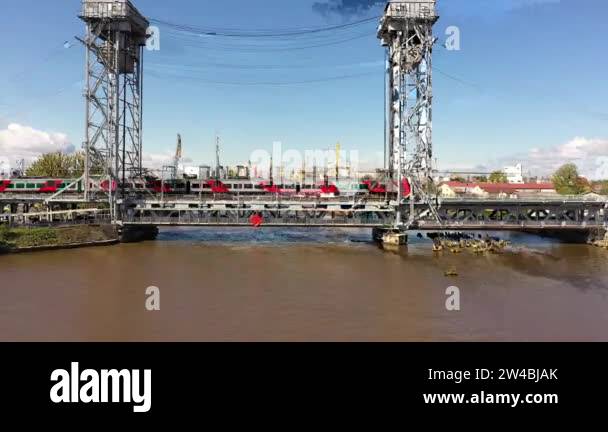 The passenger train passes over the two-tiered bridge in Kaliningrad ...