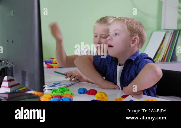 life with disabilities, boy with downs syndrome studying mathematics ...