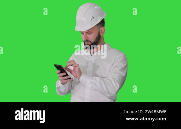 Smart engineer in white shirt and safety engineering hat using ...