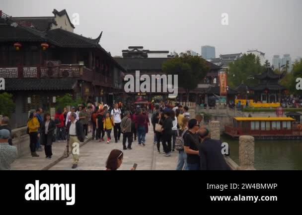 Famous old town temple riverside square with crowded bridge at Nanjing ...