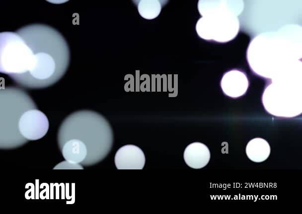 Animation of glowing spots of white light falling in hypnotic motion in ...