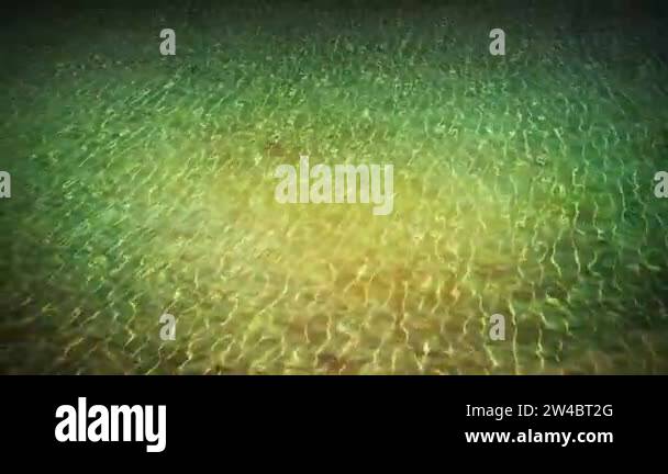 Turquoise sea water infused with sun rays. Ripples in the water from ...