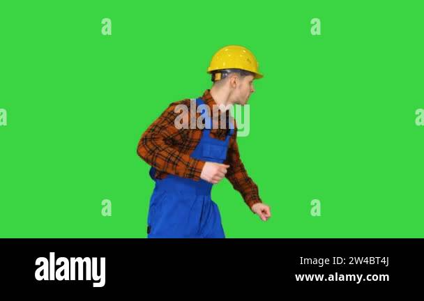 Young construction worker in hard hat dancing hip-hop on a Green Screen ...