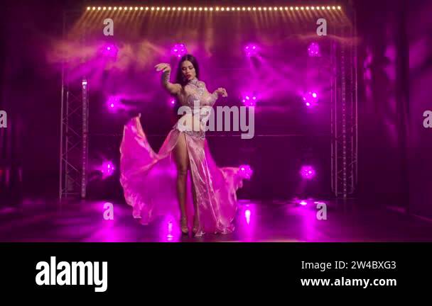 Beautiful oriental belly dancer is dancing and demonstrating the ...
