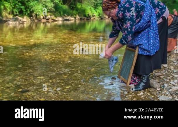 An amazing washerwoman is still working hard and washing clothes Stock ...