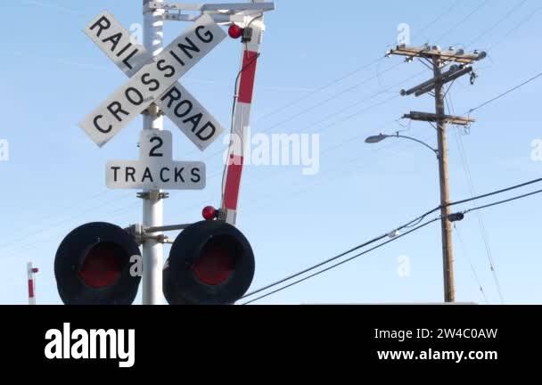 Level crossing warning signal in USA. Crossbuck notice and red traffic ...