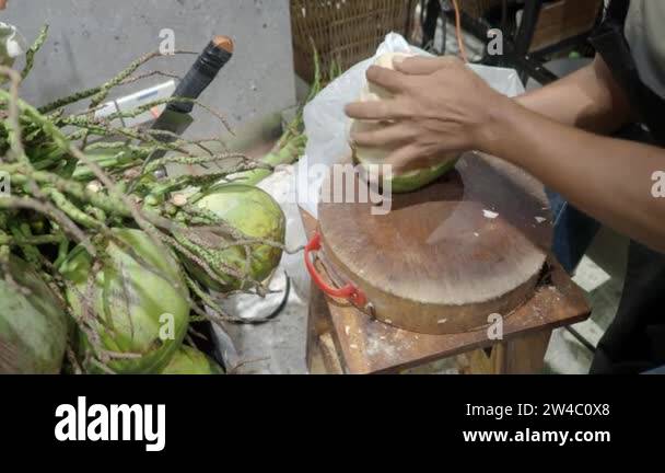 Peeling Thai coconut skin in the traditional way. Which keeping coconut ...