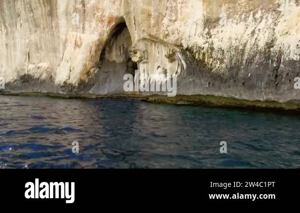 The narrow steep inlet of Portu Pedrosu cut into the limestone rock of ...