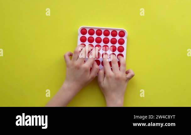Popit antistress toy for children entertainment on a yellow background ...