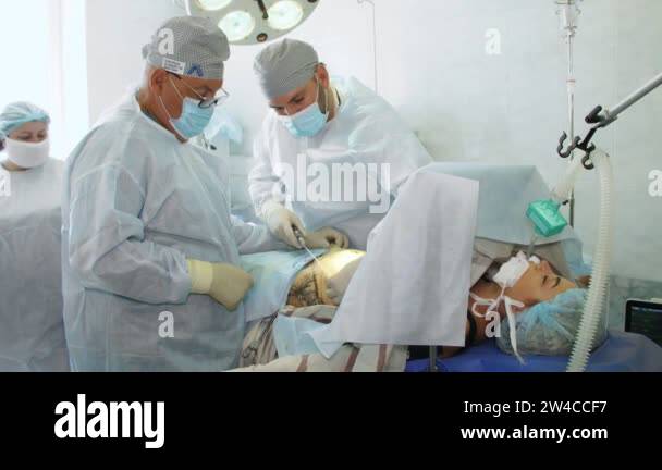 abdominal liposuction, surgery in actual operating room. surgeon pumps ...