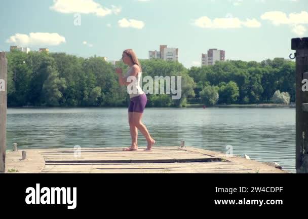Exercises for the gluteal muscle. Barefoot sports on the lake. 4k video ...