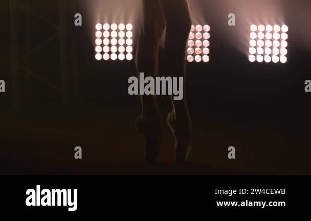 Slender legs tiptoe of a ballerina in pointe shoes. A young girl is ...