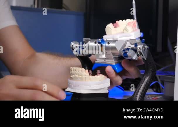 Dental technician scanning dental cast model in 3D surface scanners ...