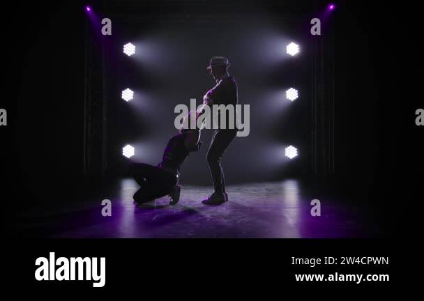 Group of male gymnasts perform acrobatic stunts on balancing ...