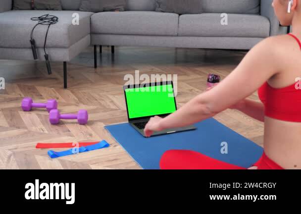Green screen laptop: Fit woman looks computer tells fitness trainer ...