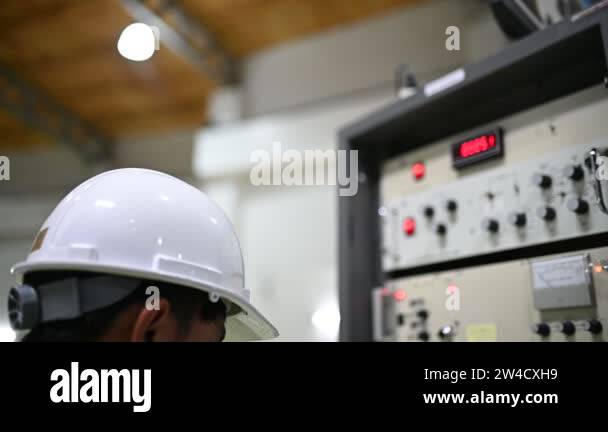 Electrical engineer man checking voltage at power distribution cabinet in control room Stock ...