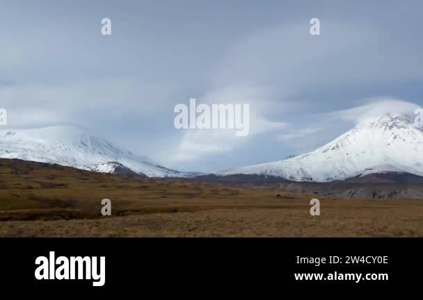 A stunning view of the group of volcanoes in Klyuchevsky Park. Aerial ...