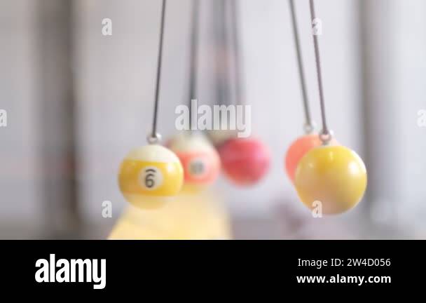 physics experiment simple Newtons cradle in motion, closeup. Metal ...