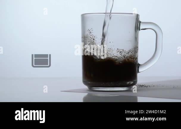 coffee is poured into a transparent cup and poured with boiling water ...