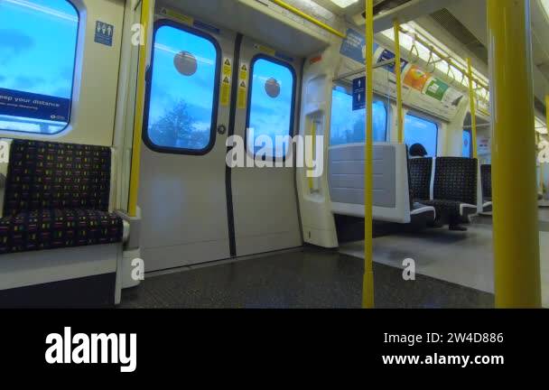 TFL Train Approaching Platform Station And Doors Opening. Viewed From ...