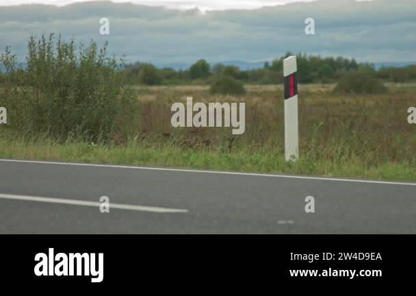 Curvy road with traffic signs in mountains. Red diagonal keep left ...